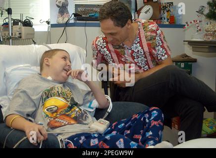 Travis Marcus of Cabot, Ark., left, jokes around with his heart doctor ...