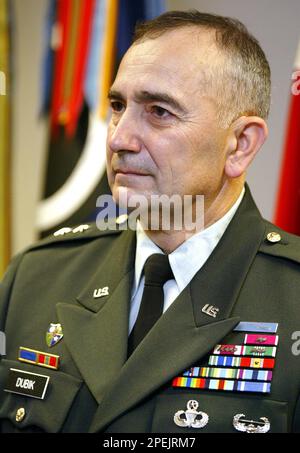 Lt. General James P. Dubik, center, stands at attention as he assumes ...