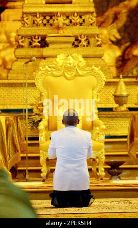 Cambodia's King Norodom Sihamoni prays in front of the nation's throne ...