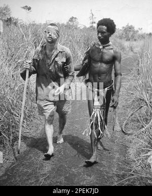 A Papua New Guinea native helps an Australian infantryman who was ...