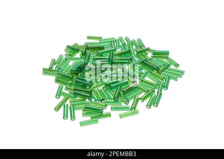 Pile of green bugle beads on white background Stock Photo - Alamy