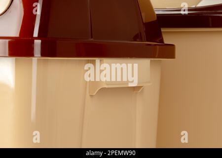 Beige plastic waste bin isolated on white Stock Photo - Alamy