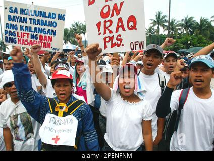 Filipino OFWs (Overseas Filipino Workers) shout slogans during a rally ...