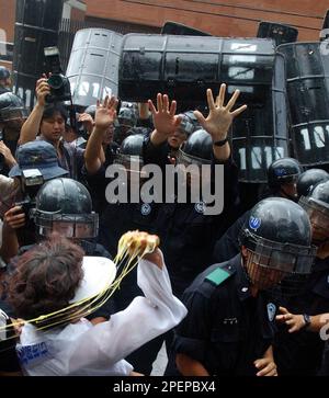 TOKYO, Japan - Riot police officers march in Tokyo's Shinjuku Ward on ...