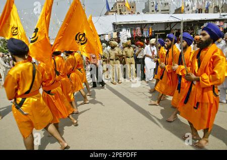 Baptised Sikhs lead a religious procession to celebrate the birth ...