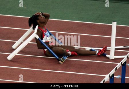 Canada's Perdita Felicien lays on the track after tripping over a ...