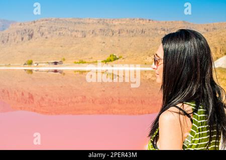 Caucasian woman tourist stand on Maharlu pink salt lake shore. Travel ...