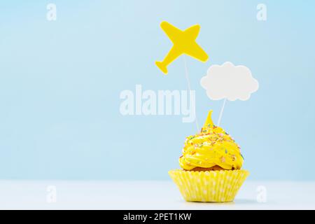 Yellow cream cupcake with speech bubble decor on blue background with copy space Stock Photo - Alamy