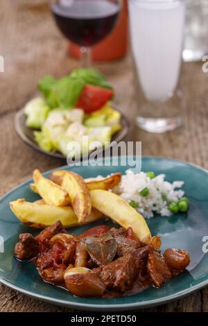 Greek stifado with french fries Stock Photo - Alamy