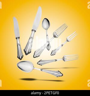 Floating Old Silverware Set with shadows on brown gradient background ...