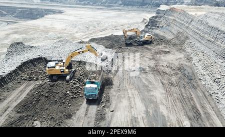 Excavators Working On Huge Mining Site, Loading The Trucks, Trucks ...