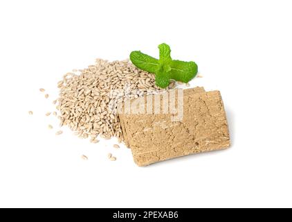 Turkish Halva with sunflower seeds and honey in wooden tray. Isolated on white background. Top ...