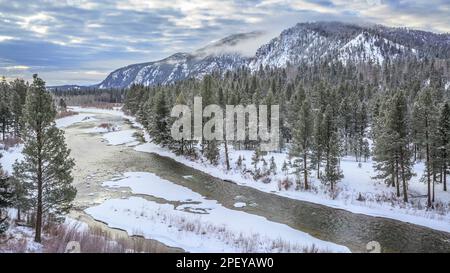 blackfoot river and cliffs of the garnet range in winter near ovando ...