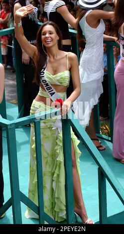 Candidates for the 2004 Miss Universe Pageant appear over a carriage ...