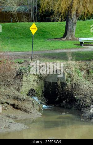 Clear sign for sewer outlet into river Stock Photo - Alamy