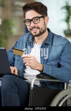 disabled person reads credit card and uses pc Stock Photo - Alamy