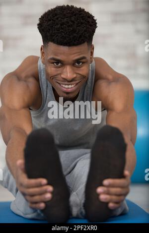 handsome young man doing hamstring stretch exercise Stock Photo - Alamy