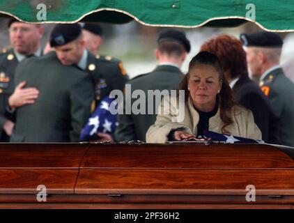 Carol Fahnestock, mother of Staff Sgt. Kimberley Voelz, right, and ...