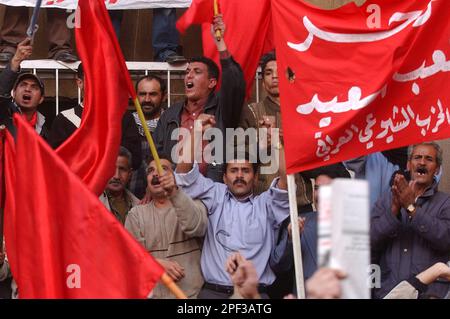 Members of the Iraqi communist party wave flags in celebration in ...
