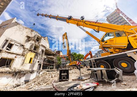 Demolition of a building, demolition excavator during the ...