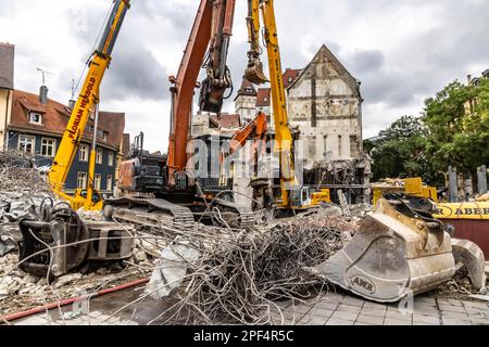 Demolition of a building, demolition excavator during the ...