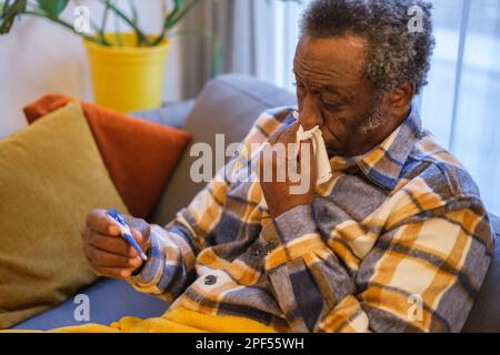 senior man blowing nose and doctor at hospital Stock Photo - Alamy