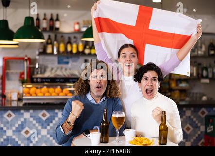 Group of people with England flag toasting with beer, having fun at ...