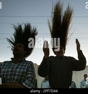 Iraqi men from the Kasnezania mystic order of Islam, some who twirl ...