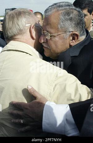 Retired US Lt. General Jay Garner, second from left, is approached by a ...