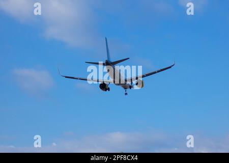 Commercial aircraft overflying the sky and arriving at airport Stock ...
