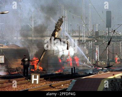 Three oil tanker freight train cars are seen together, stationary in a ...