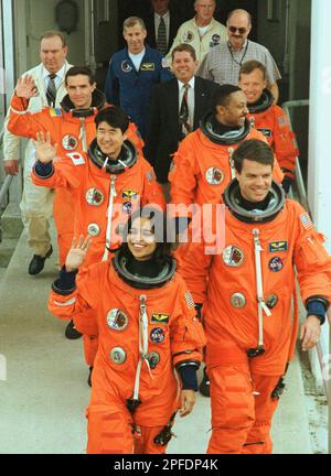 STS-87 Mission Specialist Winston Scott poses in his orange launch and ...