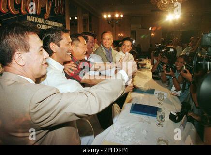 Former Secretary of Defense Ramon Magsaysay, center, receives a kiss ...