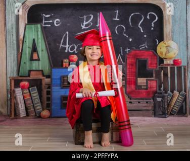 An adorable little boy proudly displaying a VPK diploma during ...