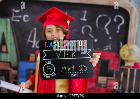 An adorable little boy holding a VPK diploma during kindergarten ...
