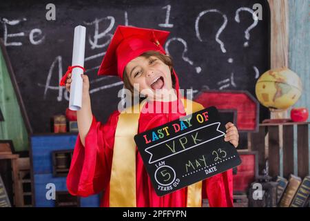 An adorable little boy holding a VPK diploma during kindergarten ...
