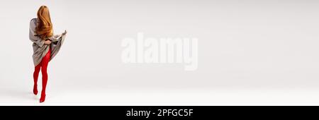 Impersonal human emotions. Stylish girl in grey coat and bright red ...