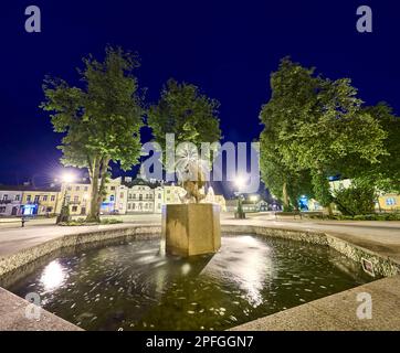 Park benches water fountain on brick sidewalk at bus stop before bright ...