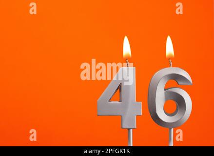 Candle number 46 - Birthday in blues foamy background Stock Photo - Alamy