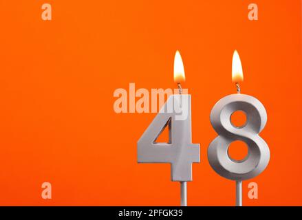 Candle number 48 - Birthday in blues foamy background Stock Photo - Alamy