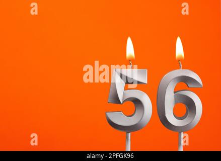 Candle number 56 - Birthday in blues foamy background Stock Photo - Alamy