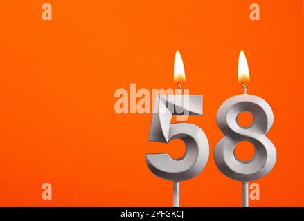 Candle number 58 - Birthday in blues foamy background Stock Photo - Alamy