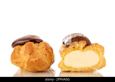 One sweet chocolate eclair cut in half, close-up, isolated on white ...