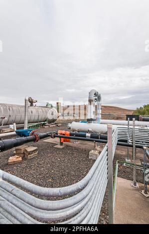 A fenced area containing tanks and piping for methane gas which is ...