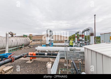 A fenced area containing tanks and piping for methane gas which is ...