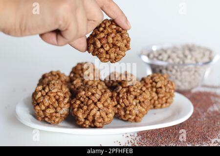 Puffed finger millet sweet ball or Ragi kurmura ladu. Sweet balls made ...