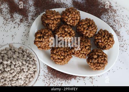 Puffed finger millet sweet ball or Ragi kurmura ladu. Sweet balls made ...
