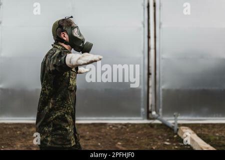 A NBC defense soldier in protective gear, pictured decontaminating a ...