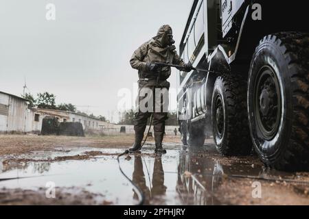 A NBC defense soldier in protective gear, pictured decontaminating a ...