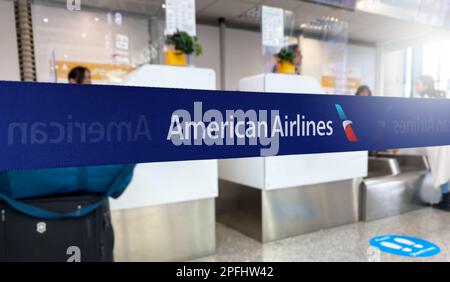 Blue barrier tape with the American Airlines logo inside an airport ...
